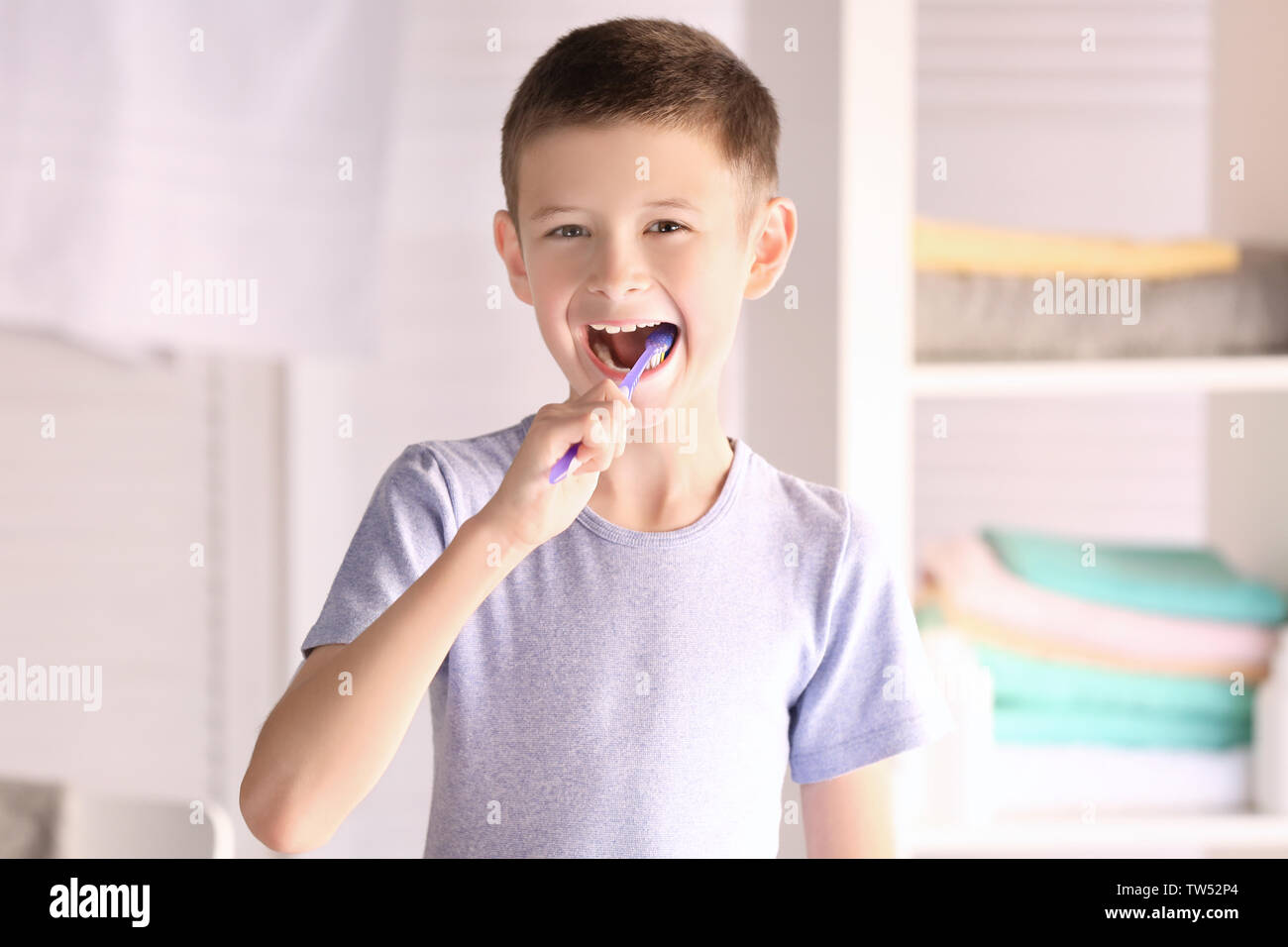 Cute little boy cleaning teeth at home Stock Photo - Alamy