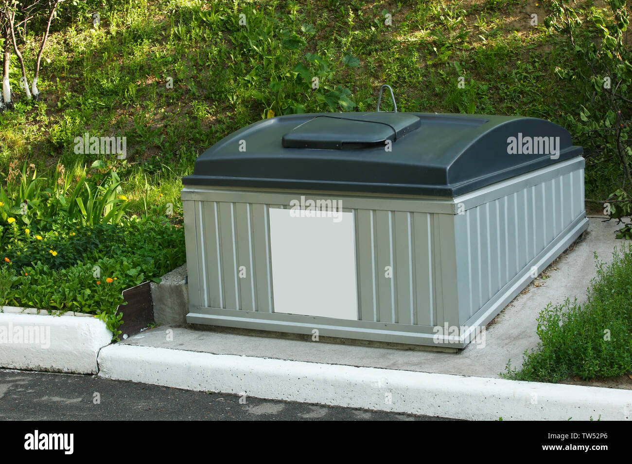 Trash container in park Stock Photo - Alamy