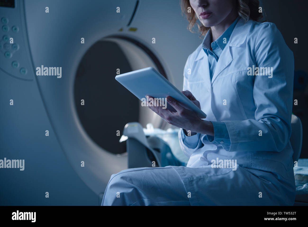 partial view of radiologist holding digital tablet with x-ray diagnosis ...