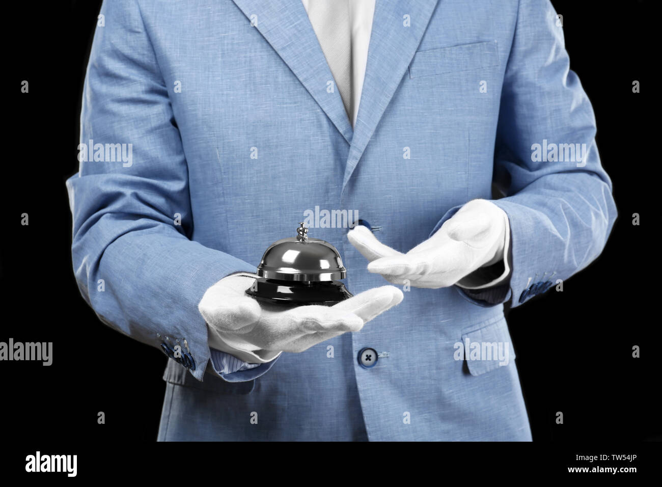 Man holding bell on black background, closeup Stock Photo - Alamy