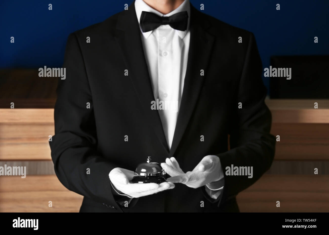 Man holding bell on blurred background Stock Photo - Alamy