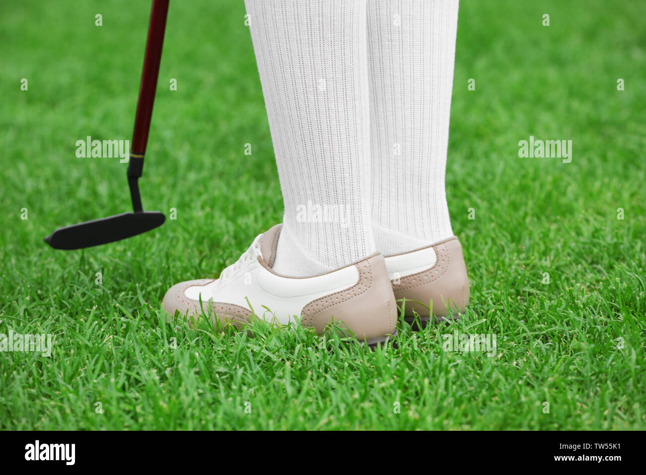 Legs of young golf player on course in summer day Stock Photo - Alamy