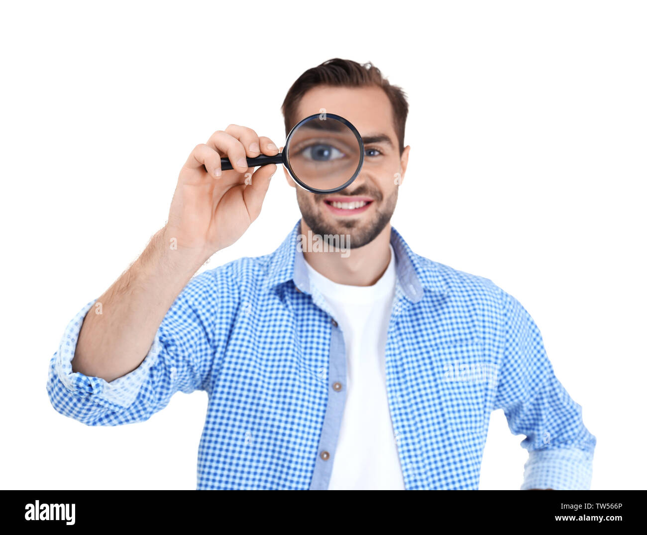 Handsome young man with magnifier on white background Stock Photo - Alamy
