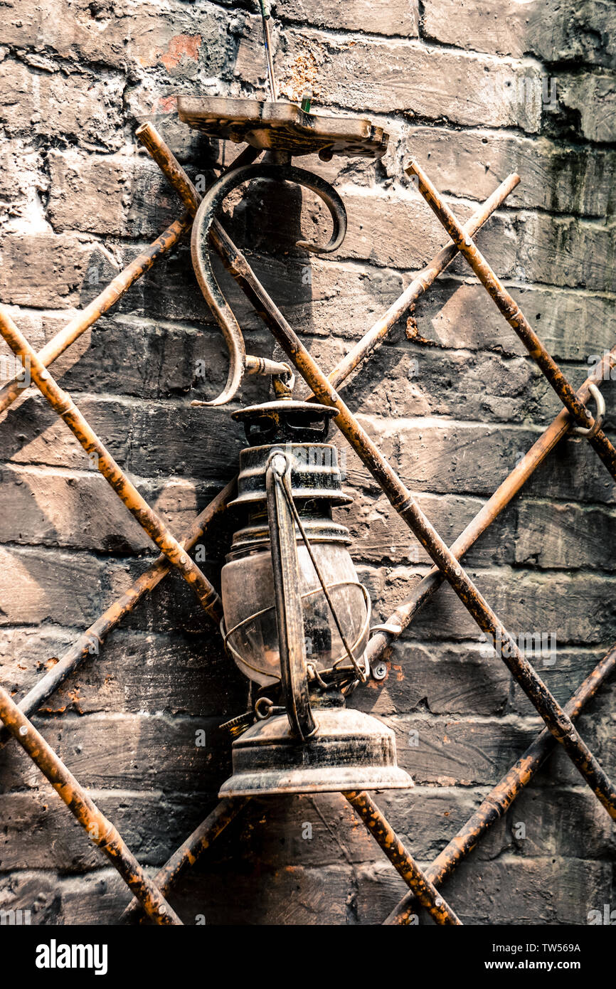 Red brick wall lone lamp, oil lamp Stock Photo - Alamy