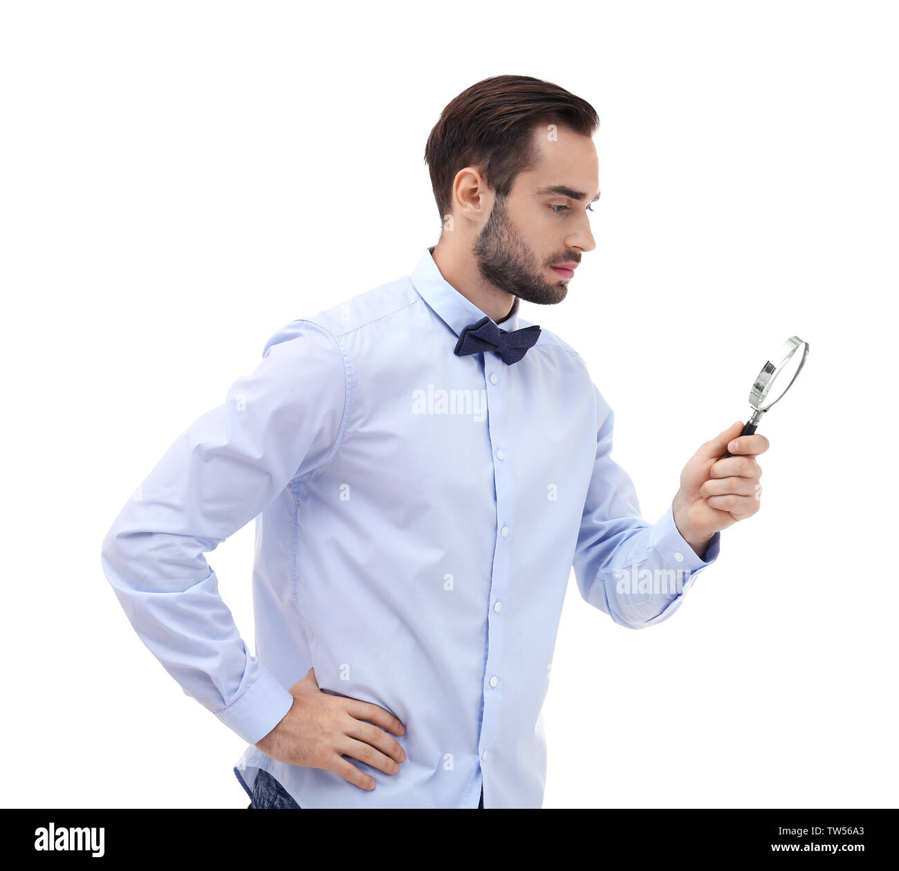 Handsome young man with magnifier on white background Stock Photo - Alamy