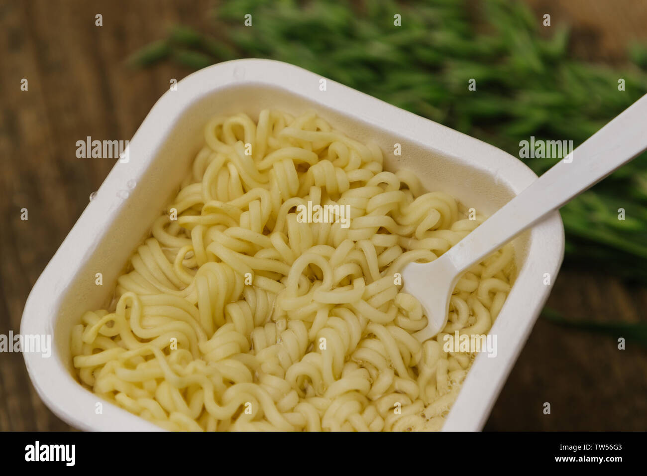 instant noodles on an old wooden table top view Stock Photo - Alamy