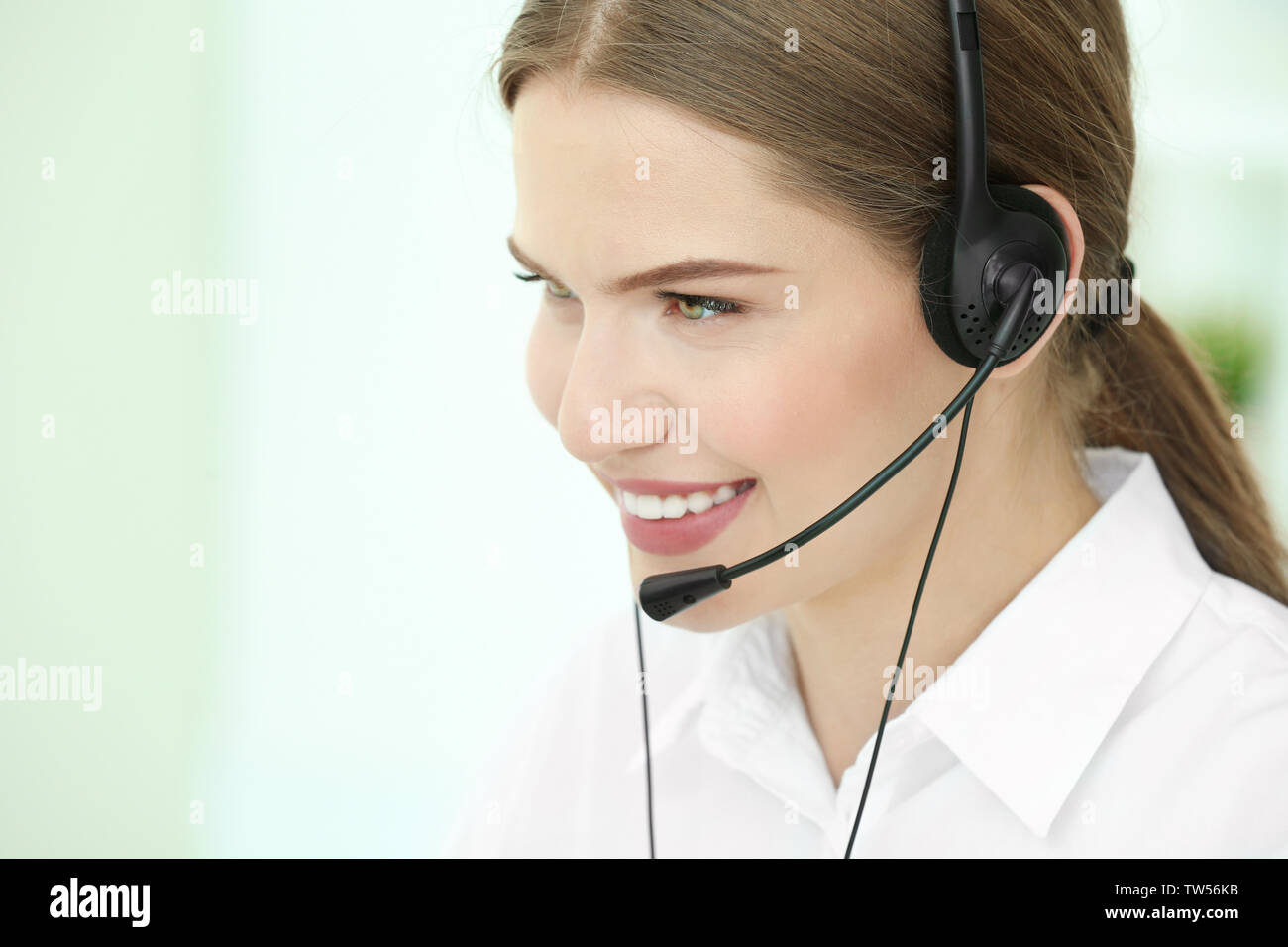 Young female technical support dispatcher working in office Stock Photo ...