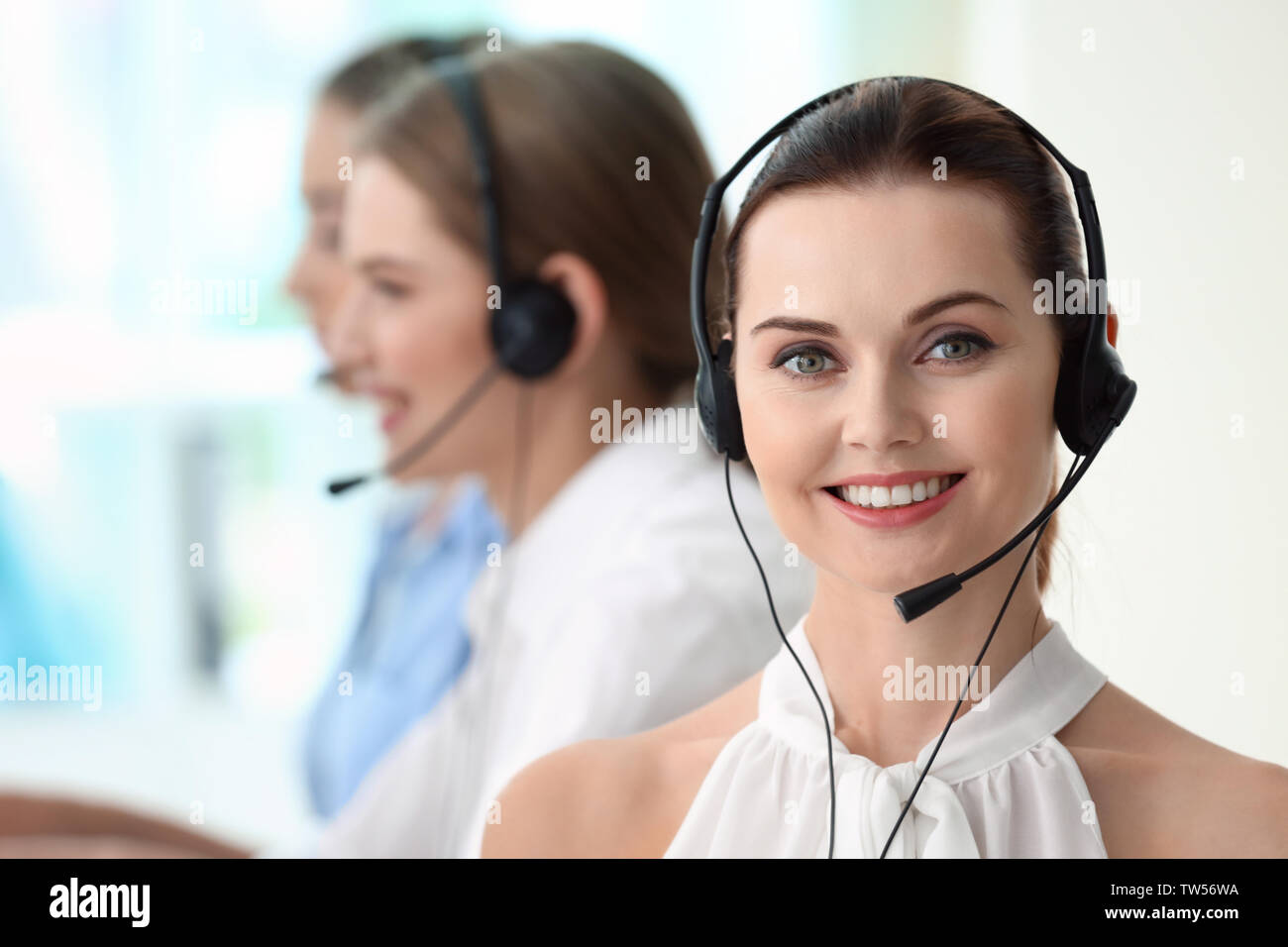 Young female employee microphone headphones hi-res stock photography ...