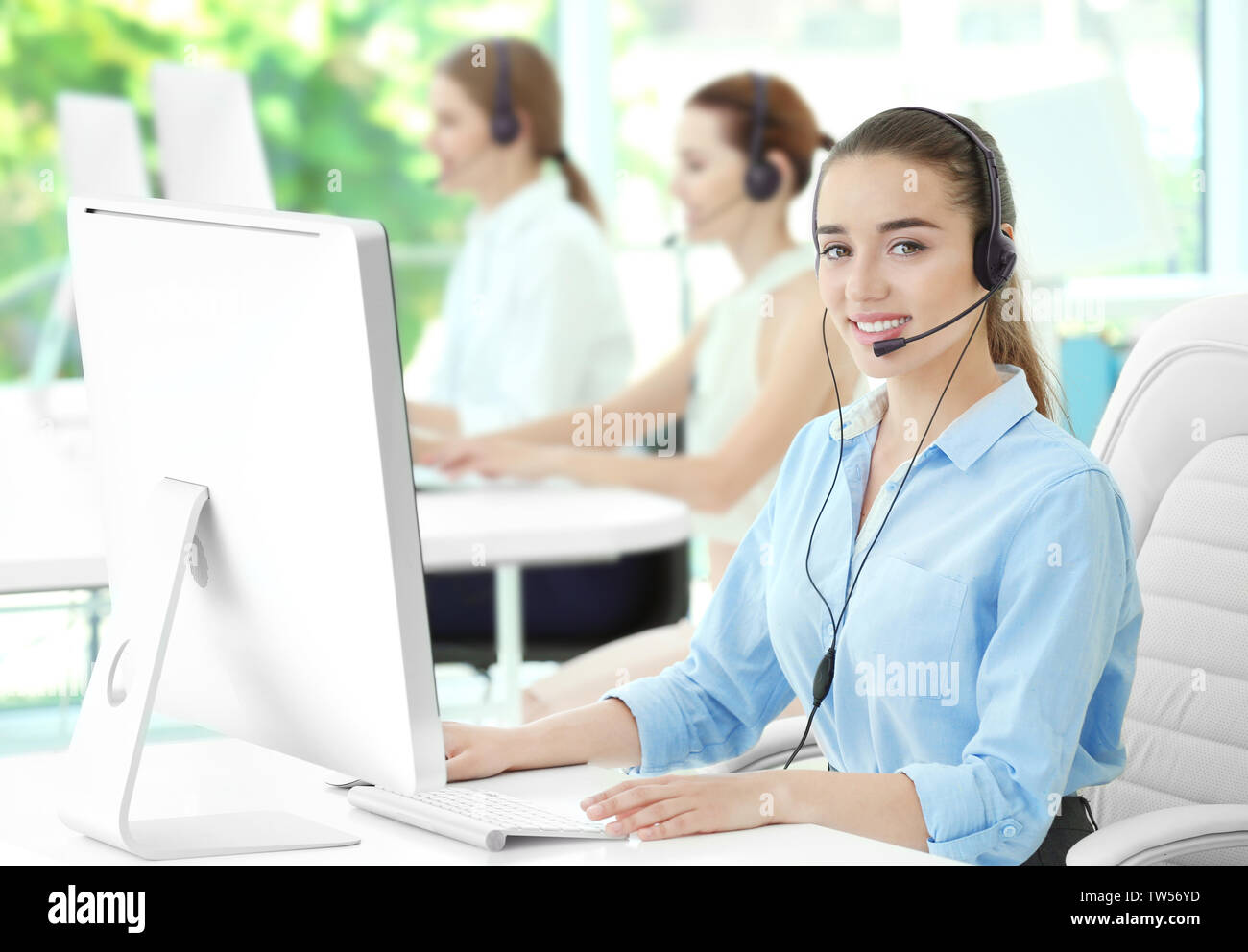 Young female technical support dispatcher working in office Stock Photo ...