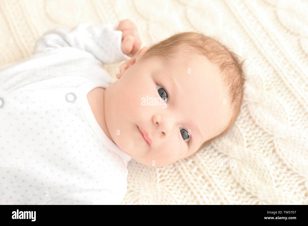Cute little baby lying on soft plaid at home Stock Photo - Alamy