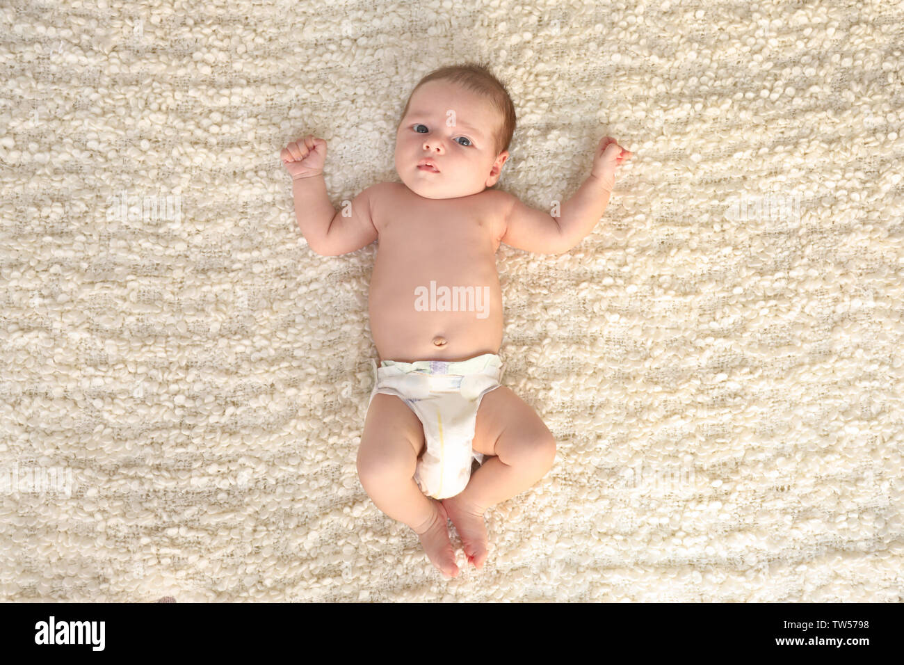 Cute little baby lying on soft plaid Stock Photo - Alamy