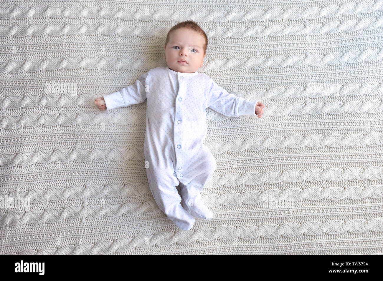 Cute little baby lying on soft plaid at home Stock Photo - Alamy