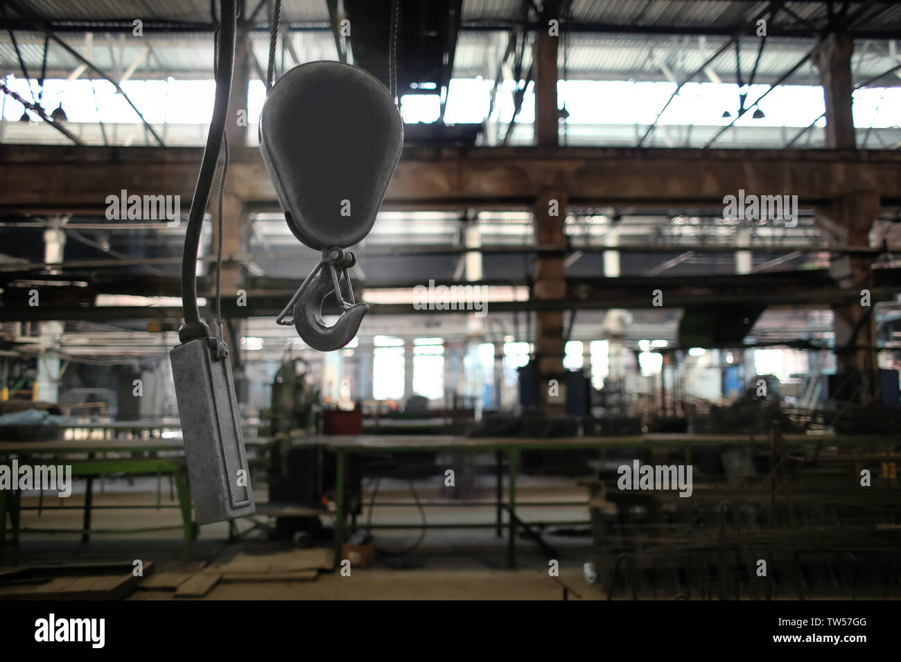 Hook of crane in factory workshop Stock Photo - Alamy