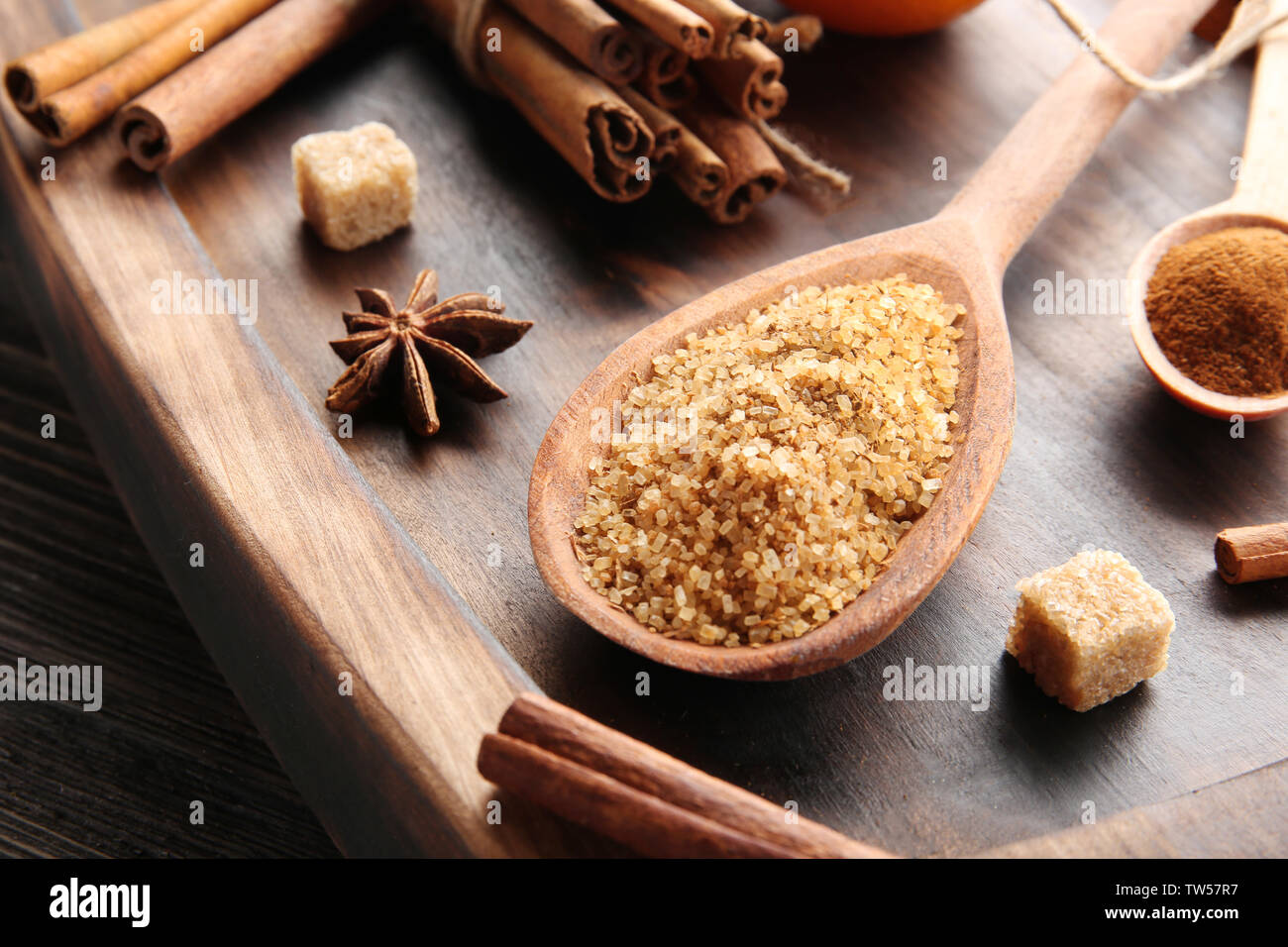 Cinnamon sugar in wooden spoon on serving board Stock Photo - Alamy