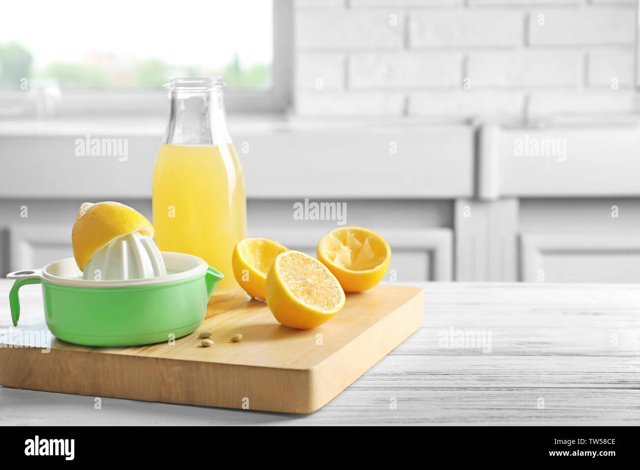 Composition with lemon squeezer on table in kitchen Stock Photo - Alamy