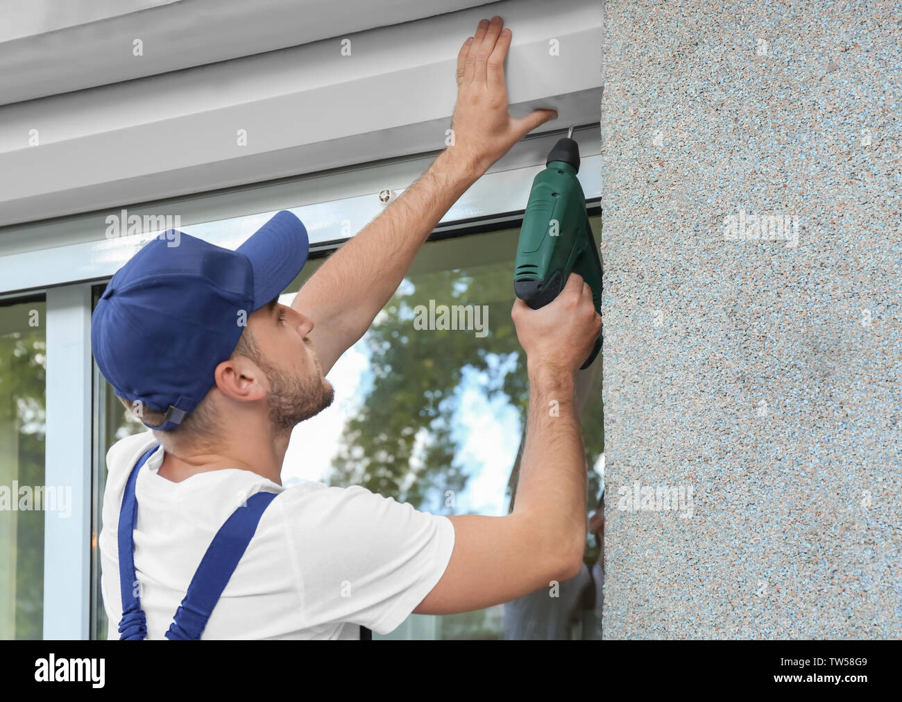 Man installing roller shutter on window Stock Photo - Alamy