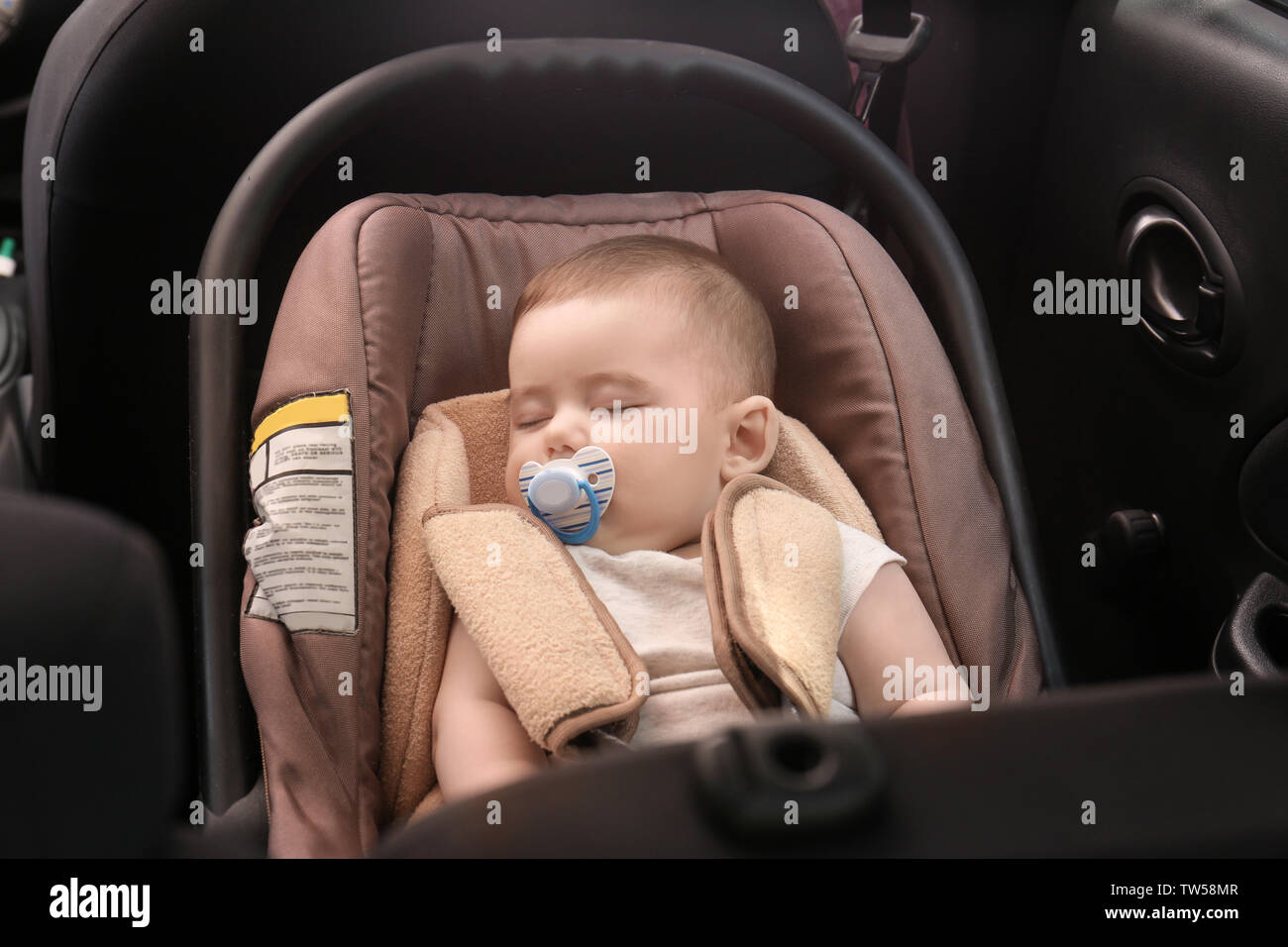Adorable baby sleeping in child safety seat inside of car Stock Photo ...