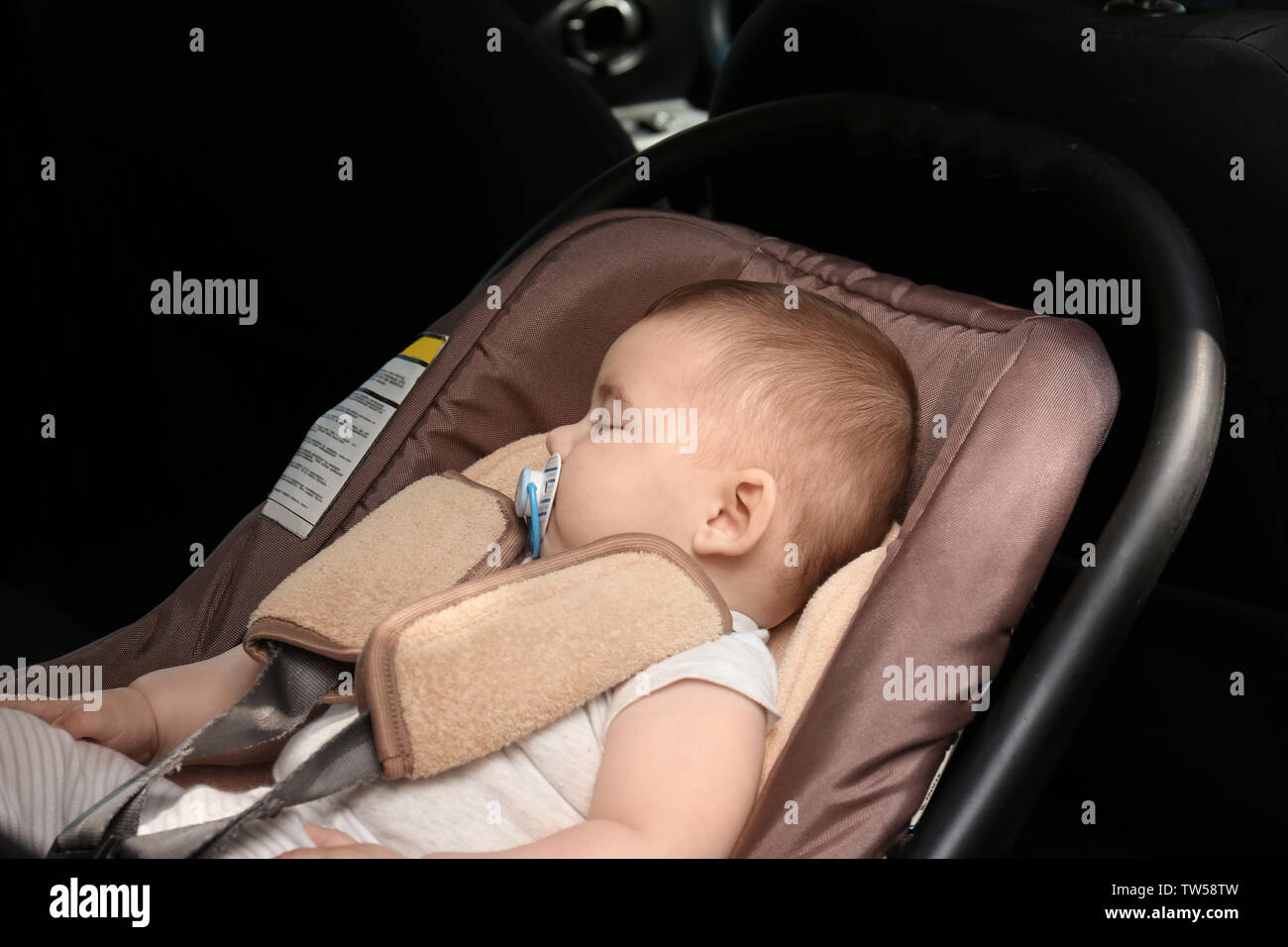 Adorable baby sleeping in child safety seat inside of car Stock Photo ...
