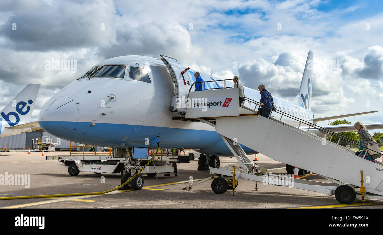 CARDIFF WALES AIRPORT - JUNE 2019: Passengers boarding an Embraer E175 ...