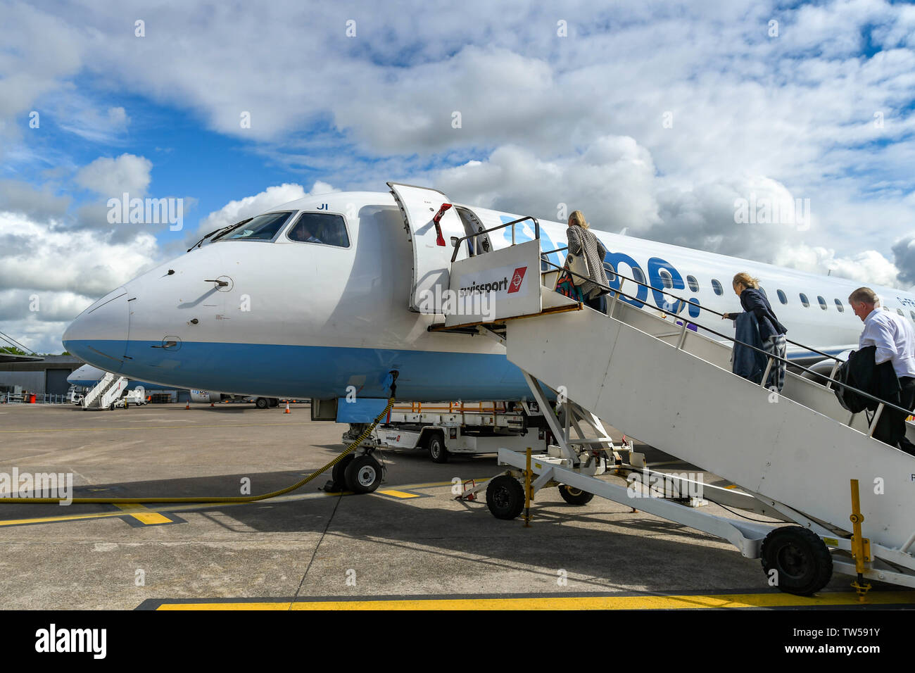 CARDIFF WALES AIRPORT - JUNE 2019: Passengers boarding an Embraer E175 ...