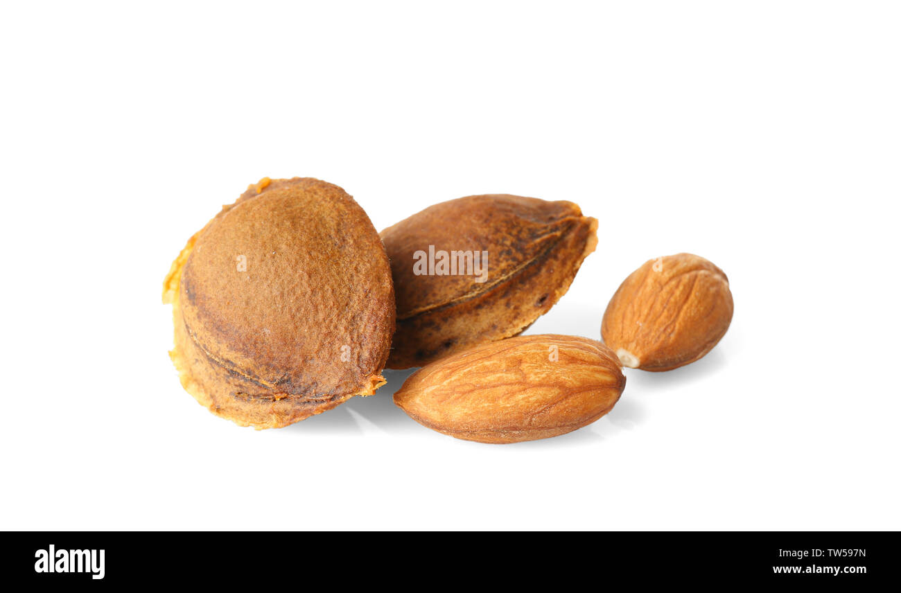 Apricot kernels on white background Stock Photo - Alamy