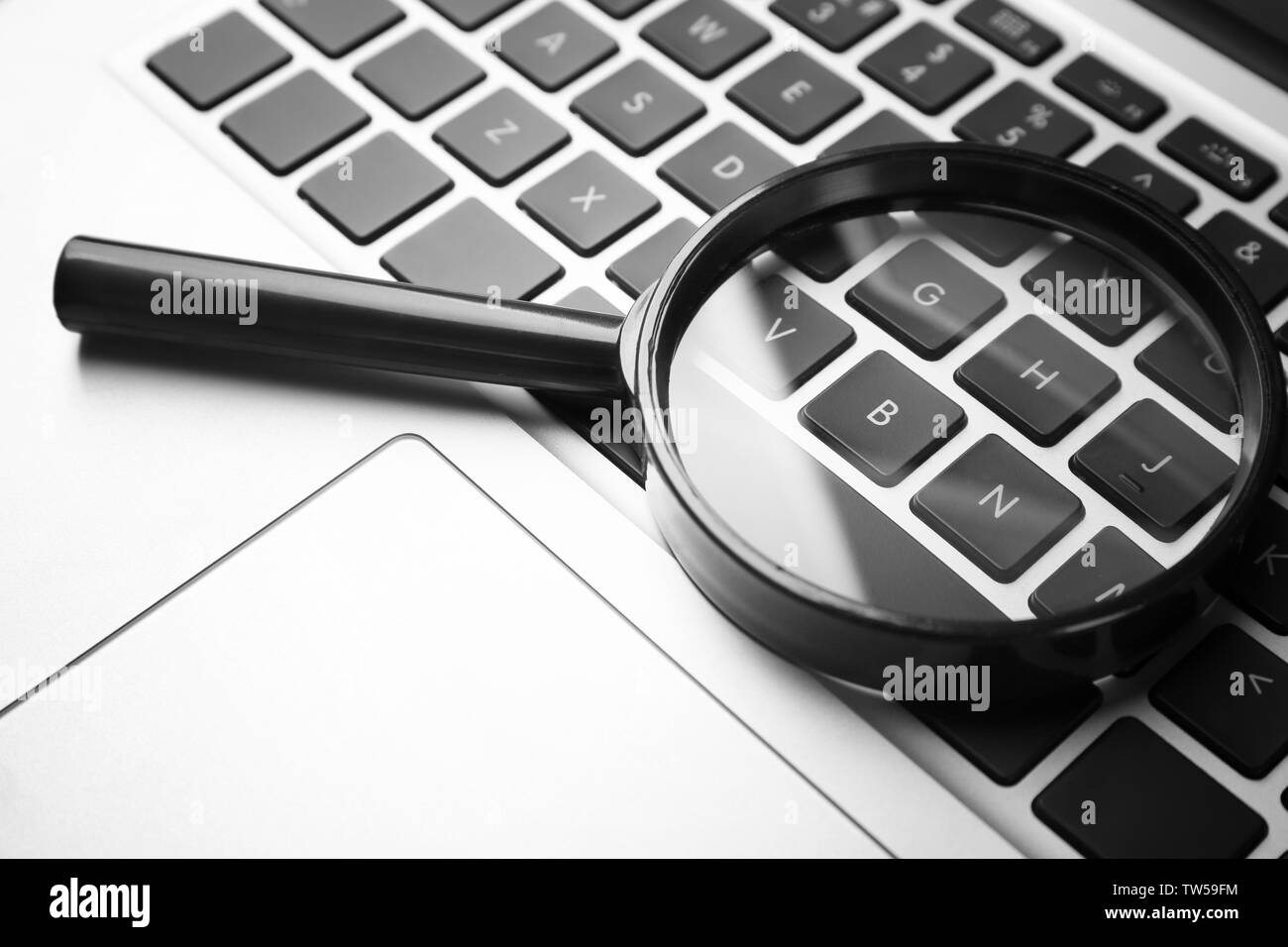 Magnifying glass on laptop. Internet search concept Stock Photo - Alamy