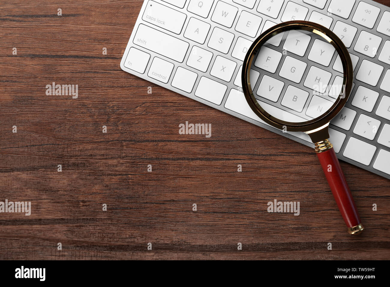 Magnifying glass on keyboard. Internet search concept Stock Photo - Alamy