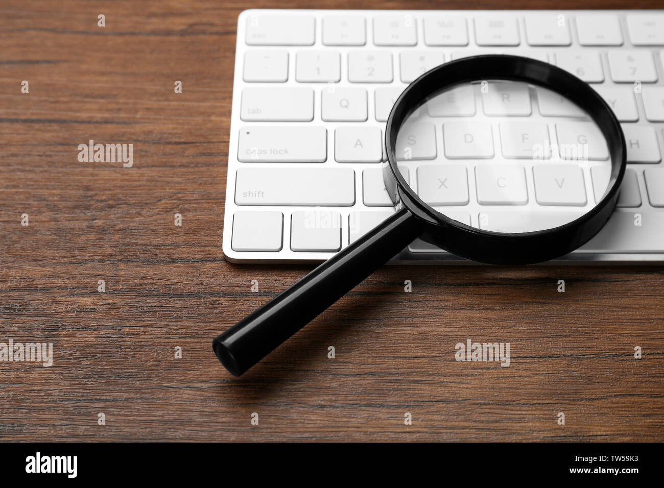 Magnifying glass on keyboard. Internet search concept Stock Photo - Alamy
