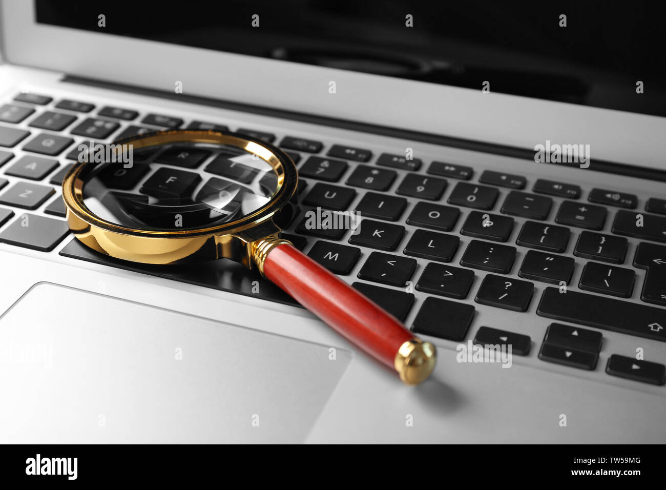 Magnifying glass on laptop. Internet search concept Stock Photo - Alamy
