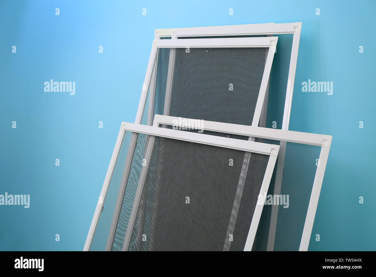 Mosquito window screens on color background Stock Photo - Alamy