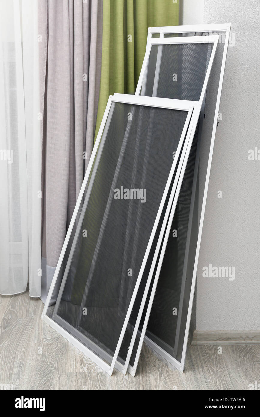 New mosquito window screens indoors Stock Photo - Alamy