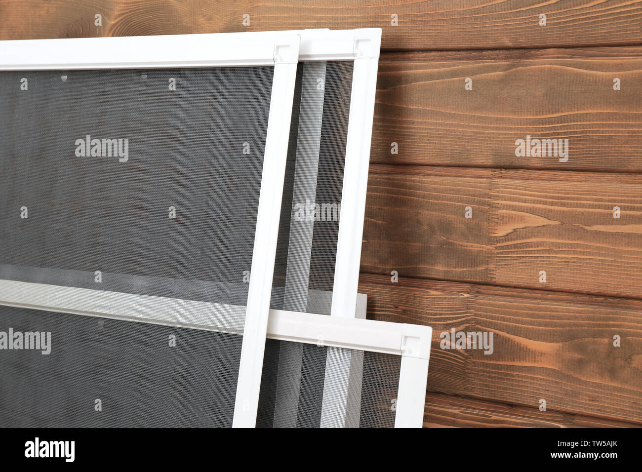 Mosquito window screens on wooden background Stock Photo - Alamy