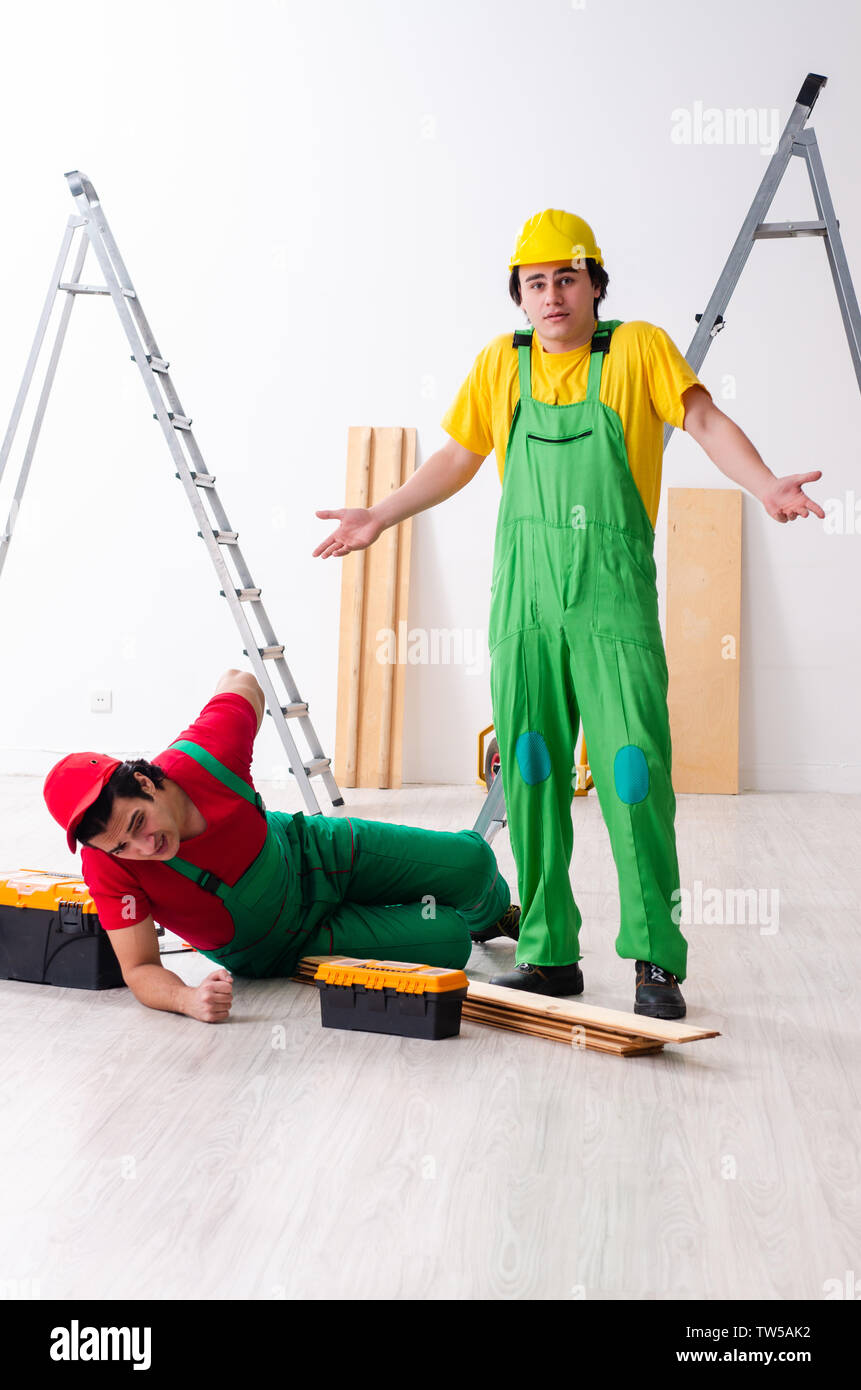 Injured worker and his workmate Stock Photo - Alamy