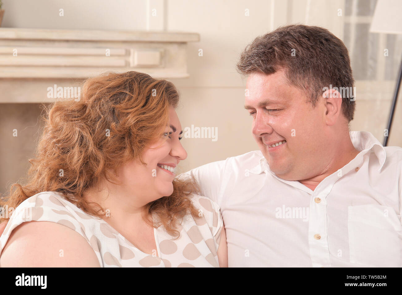 Overweight couple at home Stock Photo - Alamy