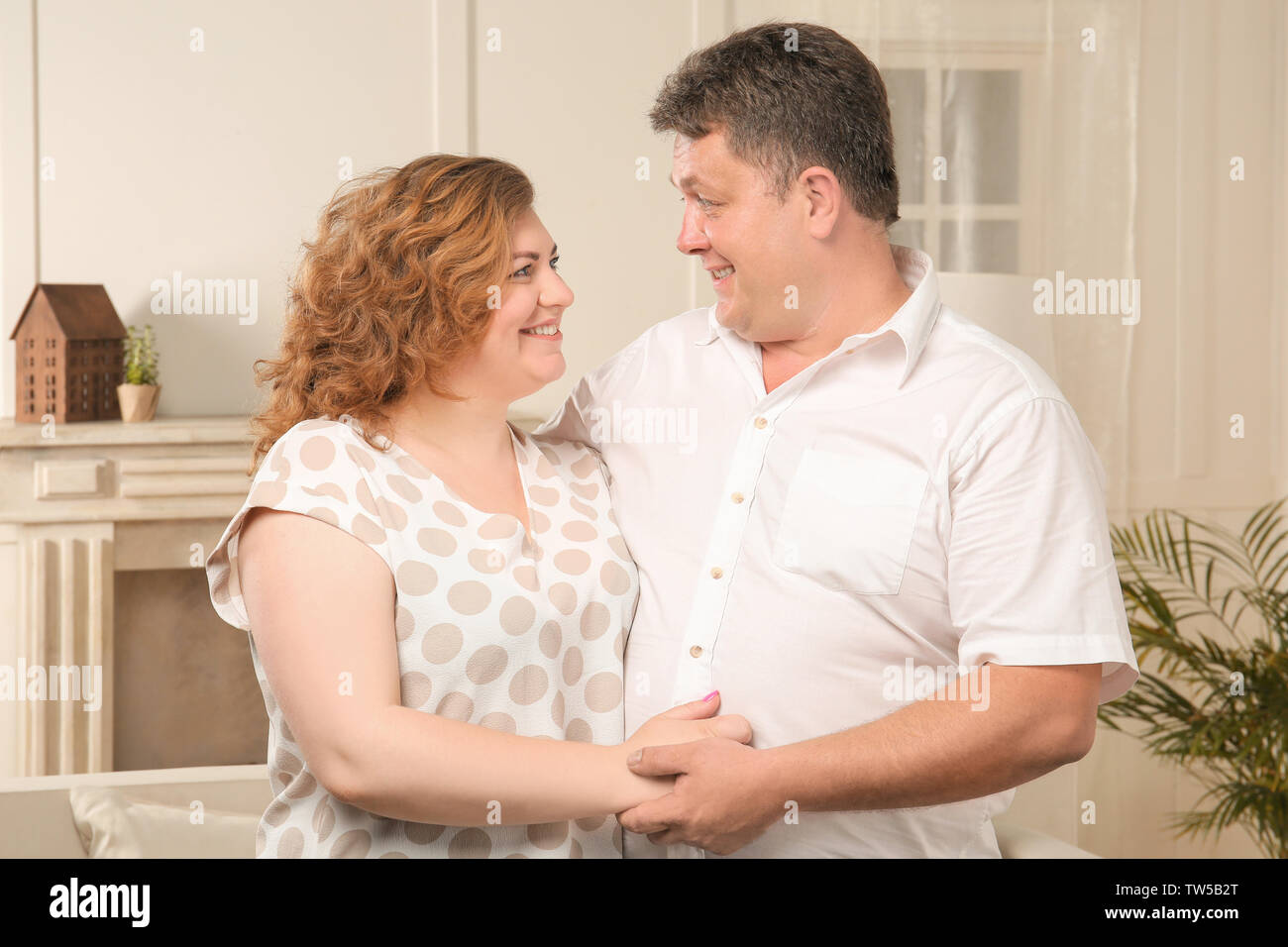 Overweight couple at home Stock Photo - Alamy