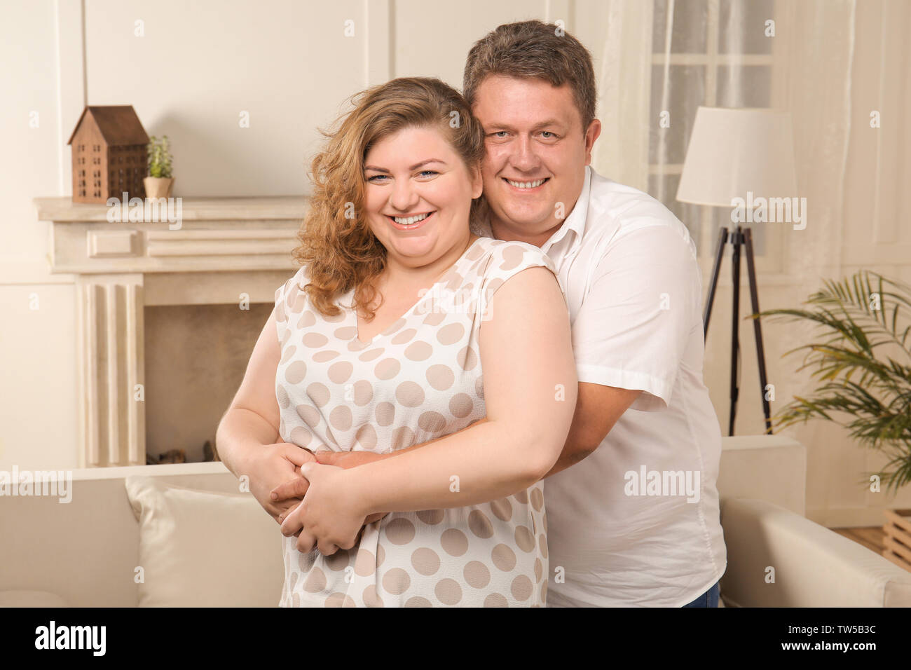 Overweight couple at home Stock Photo - Alamy