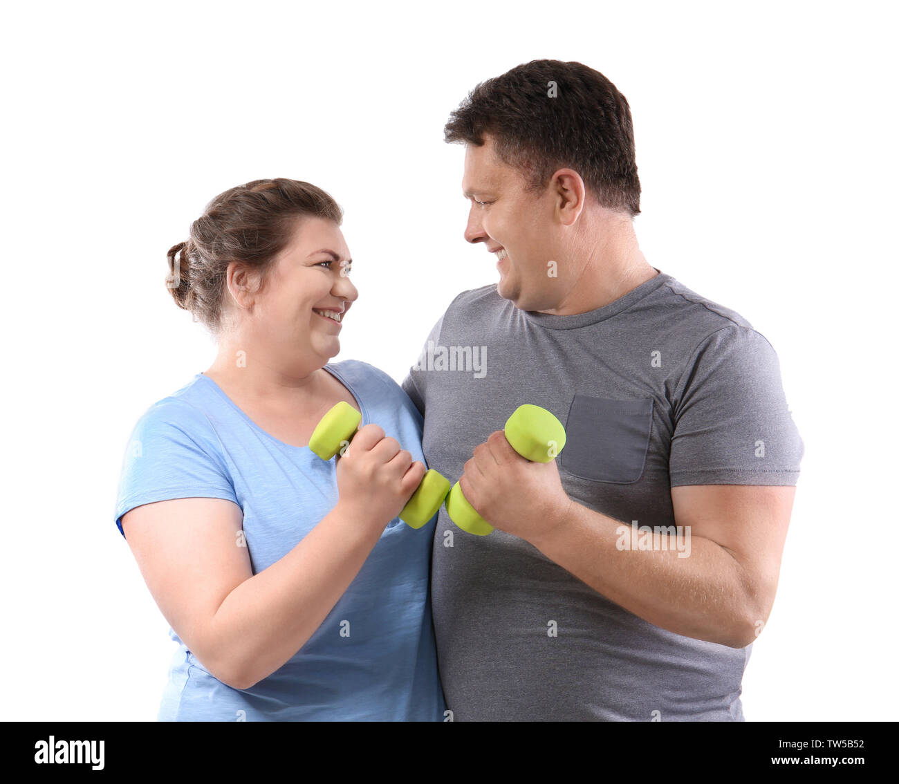 Overweight couple training together on white background Stock Photo - Alamy