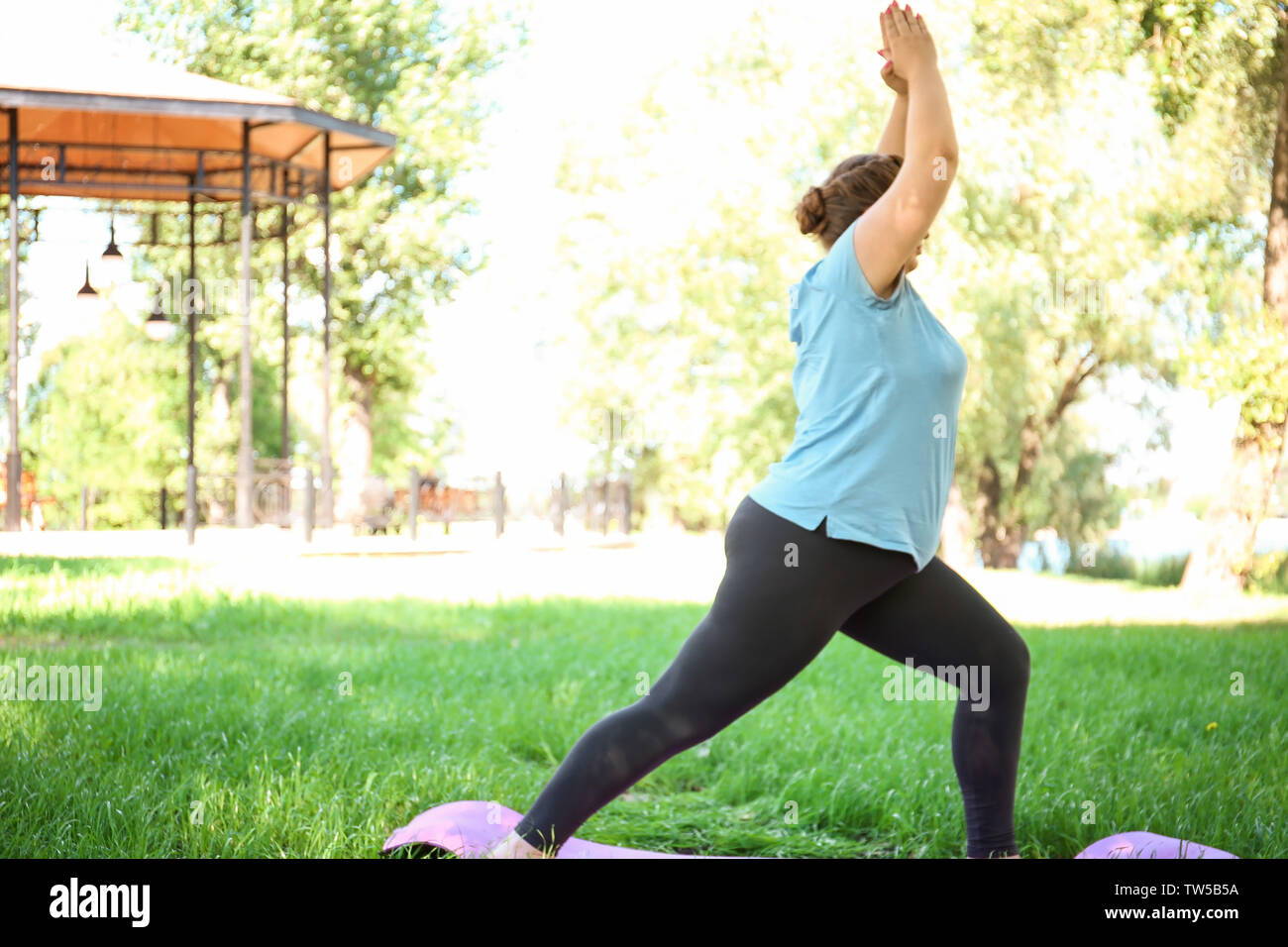 Overweight woman training on green grass Stock Photo - Alamy
