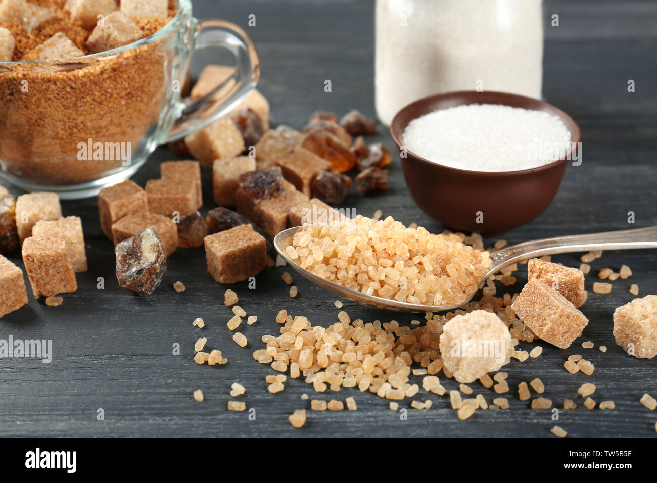 Different kinds of sugar on grey table Stock Photo - Alamy