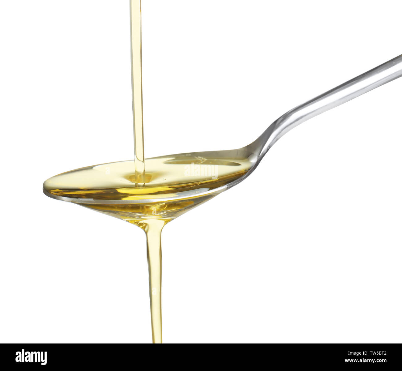 Pouring cooking oil into spoon on white background Stock Photo - Alamy