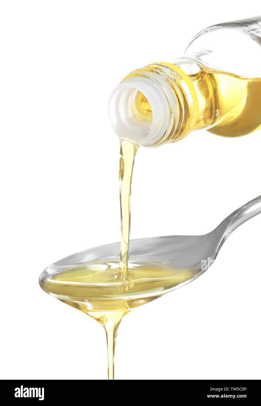 Pouring cooking oil into spoon on white background Stock Photo - Alamy