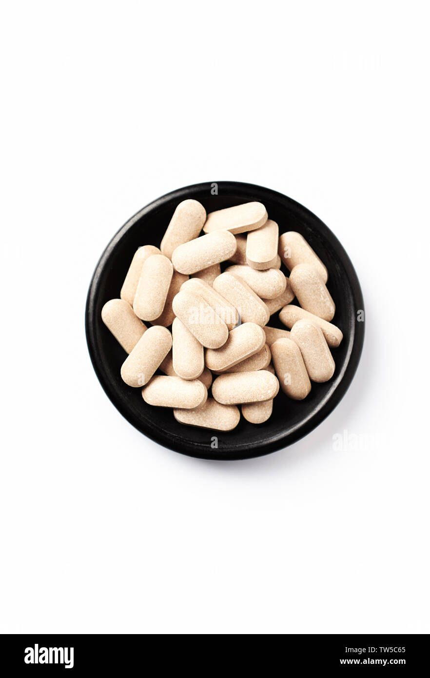 Rose root herbal pills with healthy medical plant hi-res stock ...