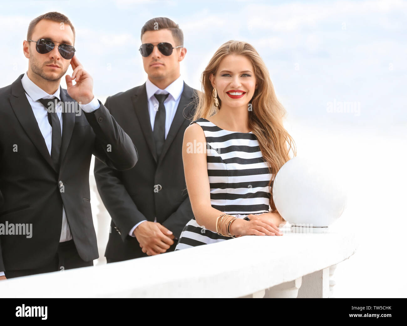 Young celebrity with bodyguards outdoors Stock Photo - Alamy
