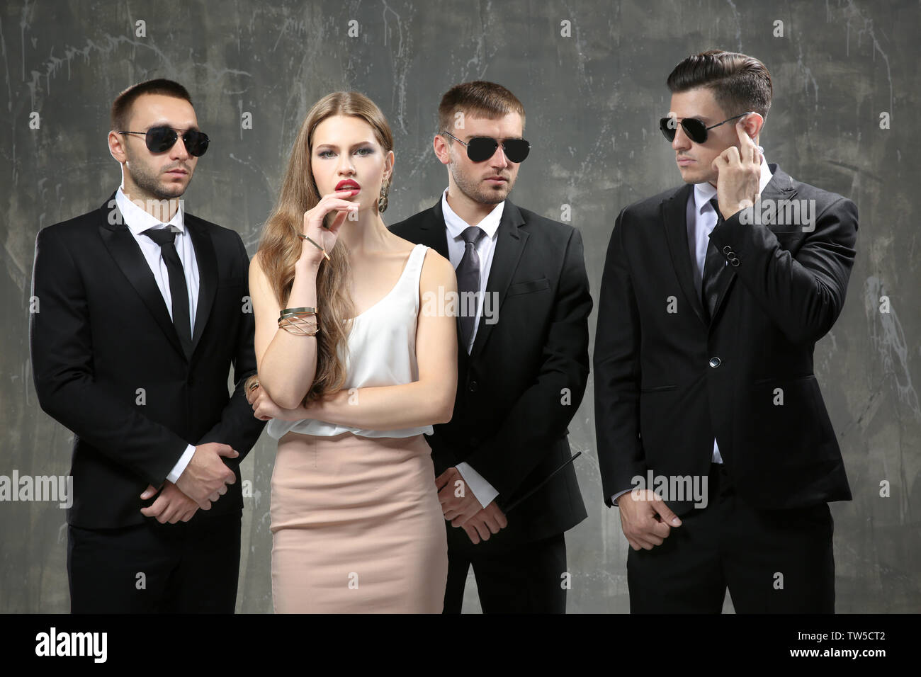 Famous celebrity with bodyguards on grunge background Stock Photo - Alamy