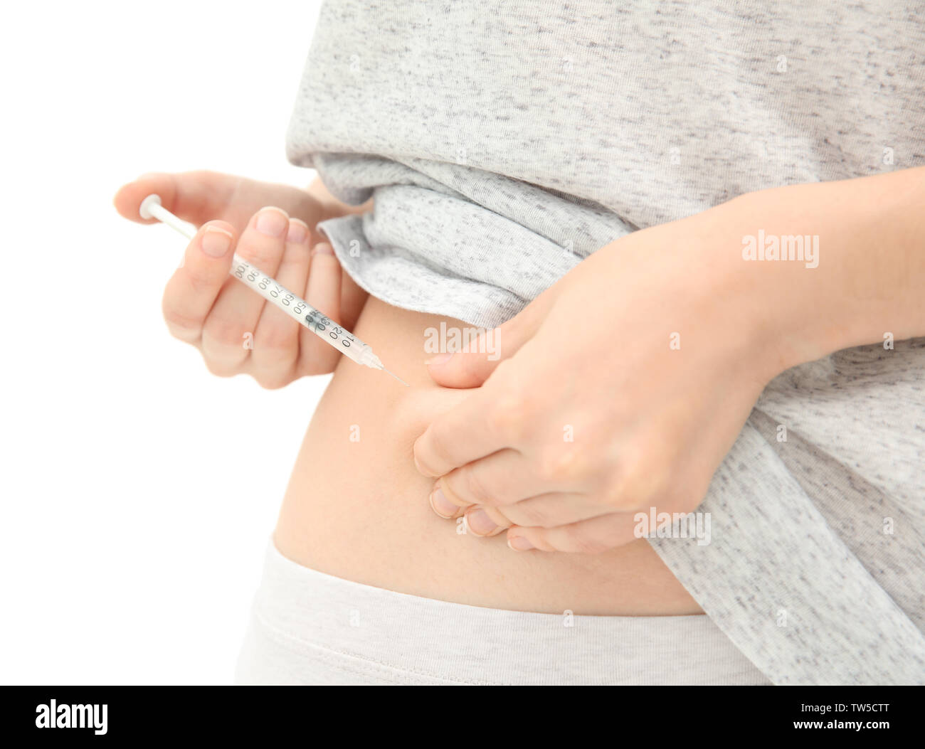 Diabetic patient injecting insulin in stomach on white background ...