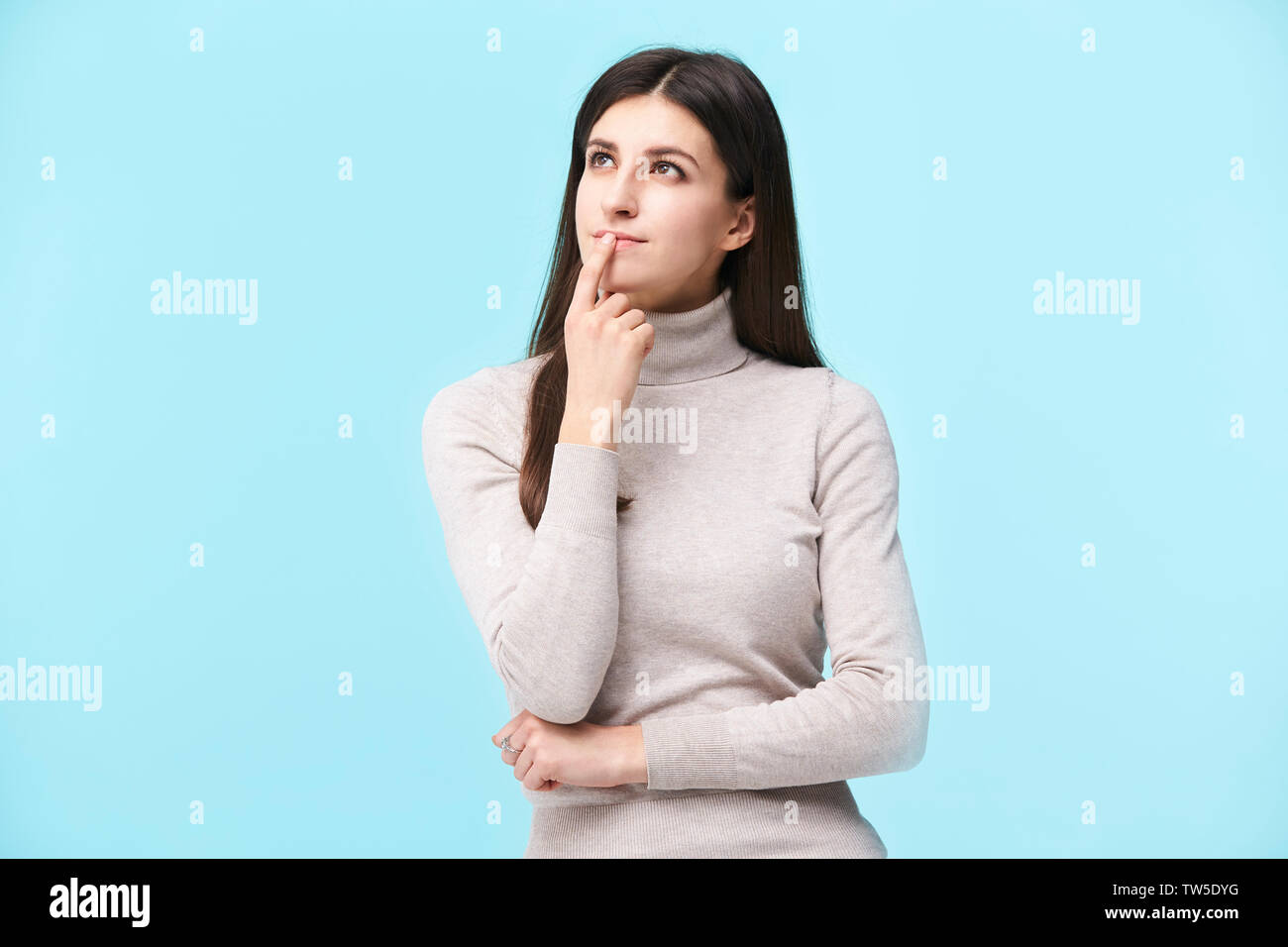 Contemplating woman finger on lips hi-res stock photography and images ...