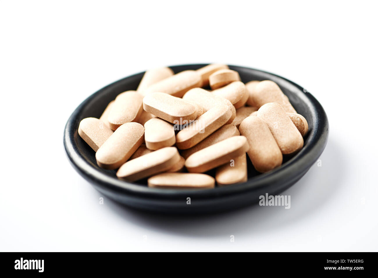 Rose root herbal pills with healthy medical plant hi-res stock ...