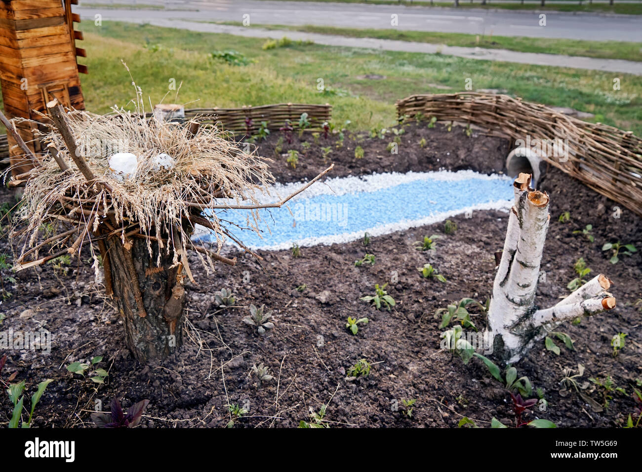 Garden with artificial nest and stream of rubble. Recycling concept ...