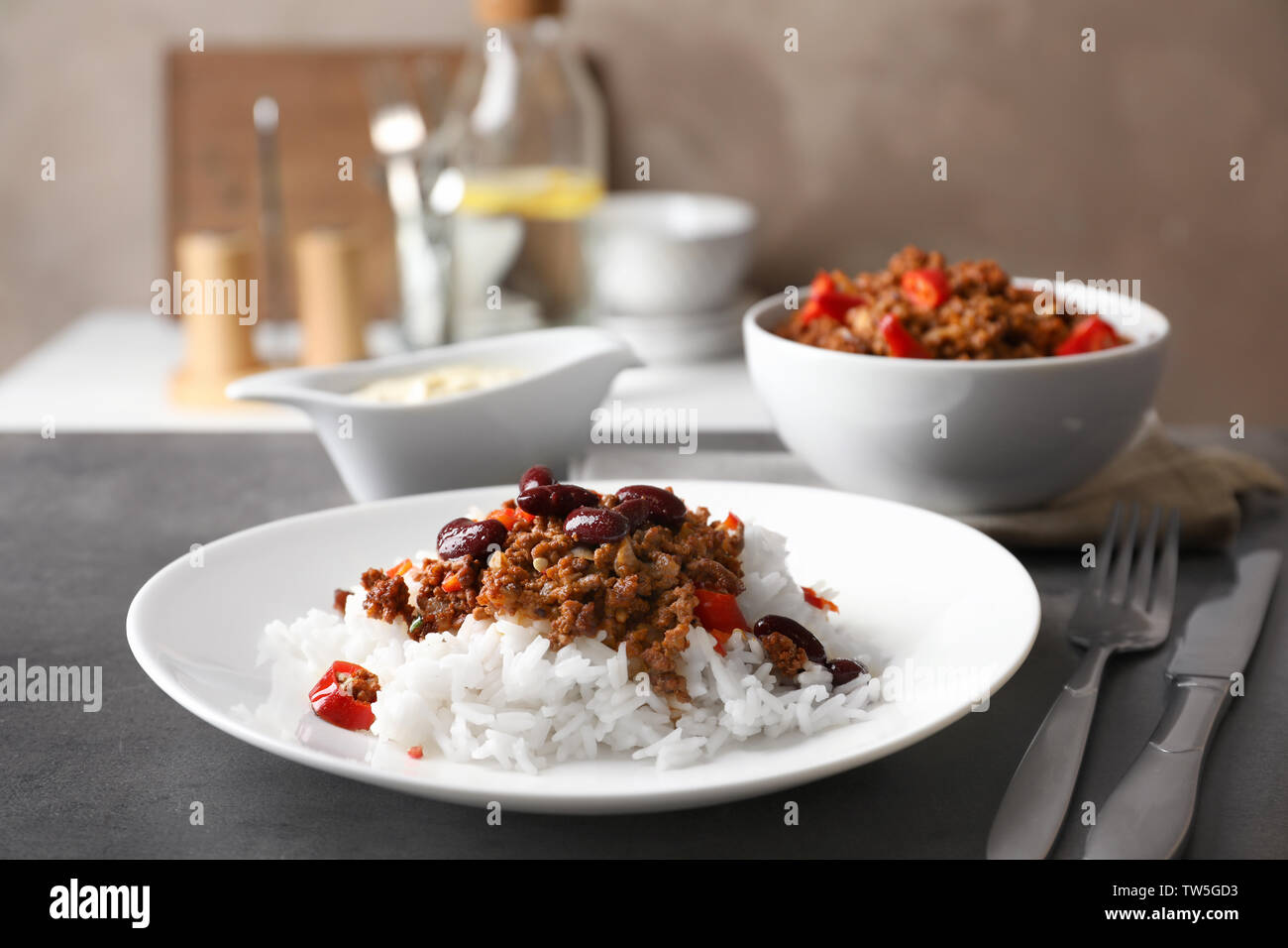 Chili con carne served with rice on table Stock Photo - Alamy