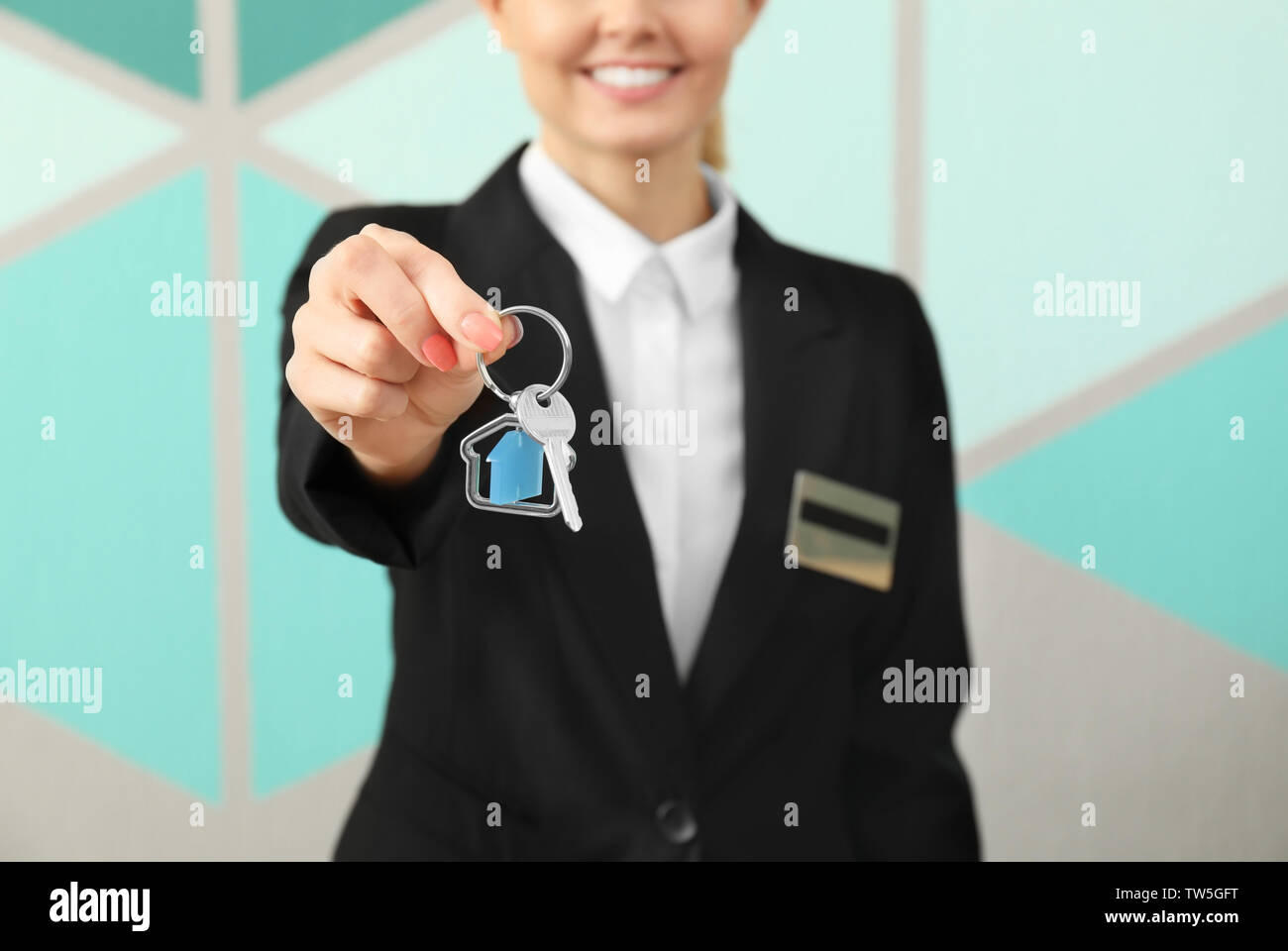 Female receptionist with room key in hotel Stock Photo - Alamy